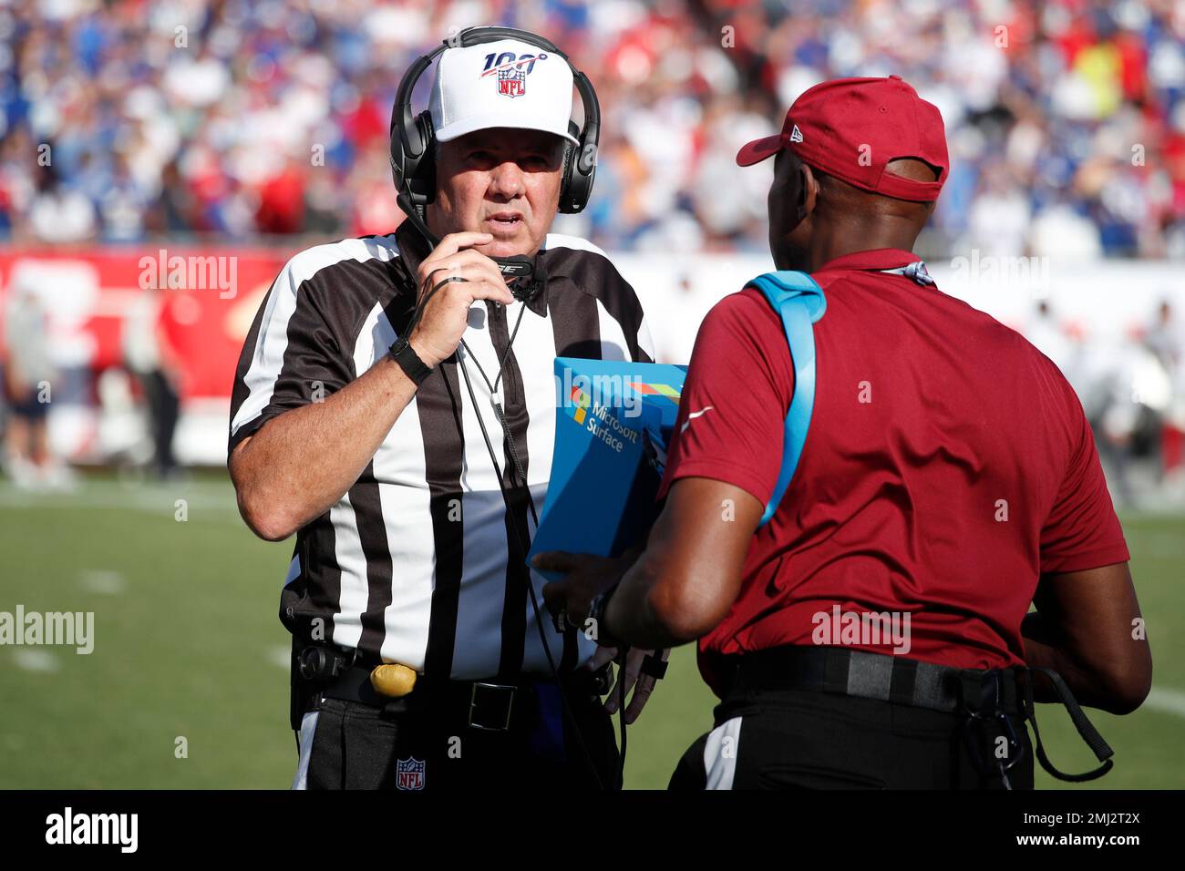 NFL referee Bill Vinovich looks over a review during an NFL football ...