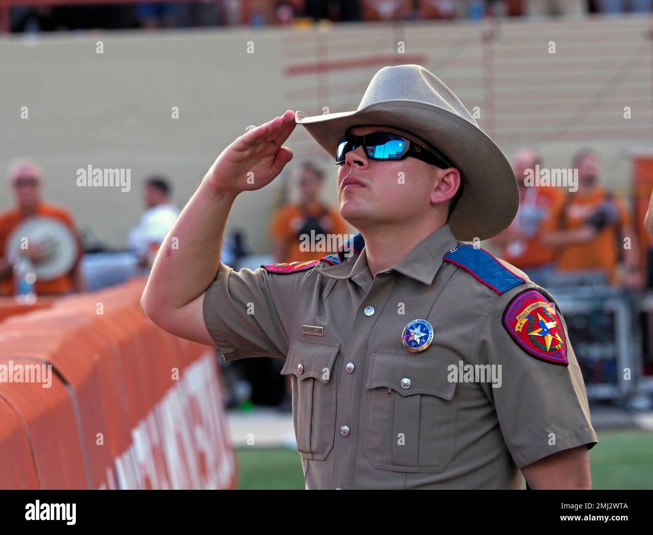 A Texas State Trooper salutes during the National Anthem before an NCAA ...