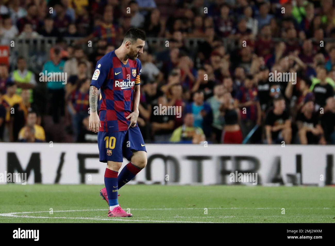 Barcelona's Lionel Messi walks on the pitch after getting hurt during ...