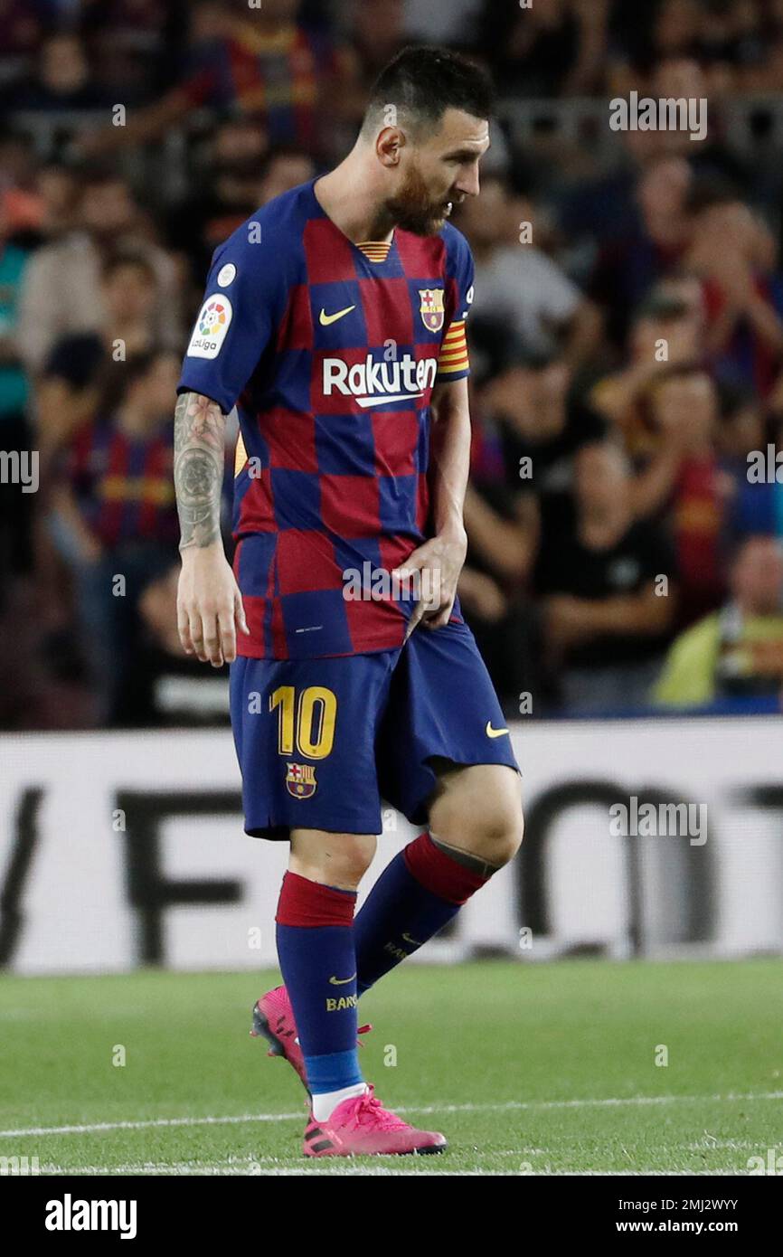 Barcelona's Lionel Messi walks on the pitch after getting hurt during ...