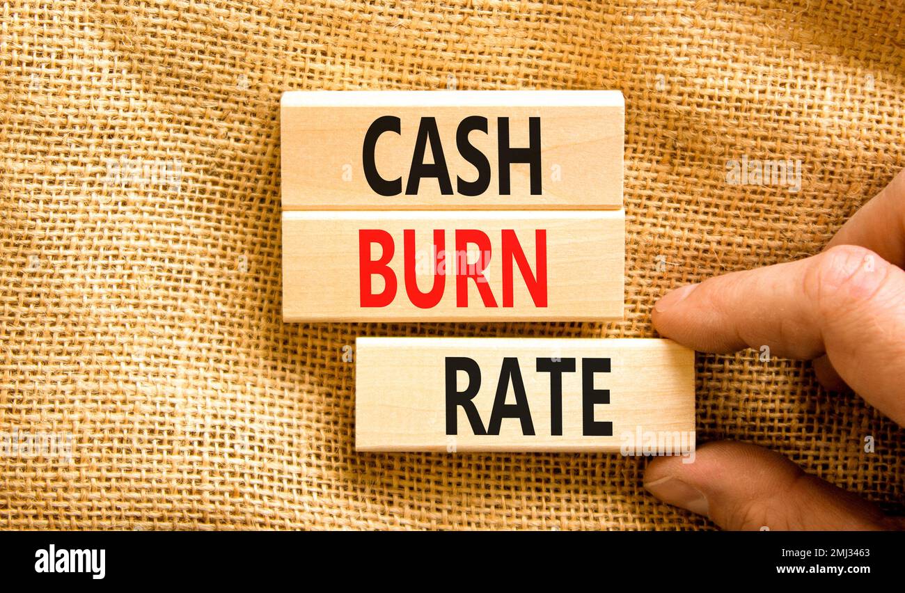 Cash burn rate symbol. Concept words Cash burn rate on wooden blocks on ...