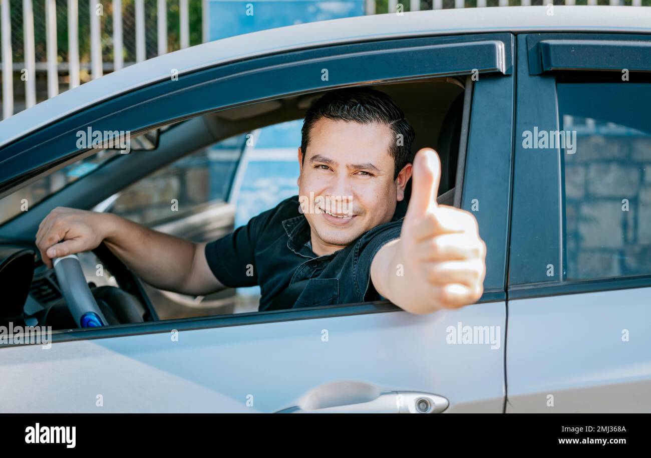 Happy Driver giving a thumbs up. Satisfied driver man showing thumb up ...