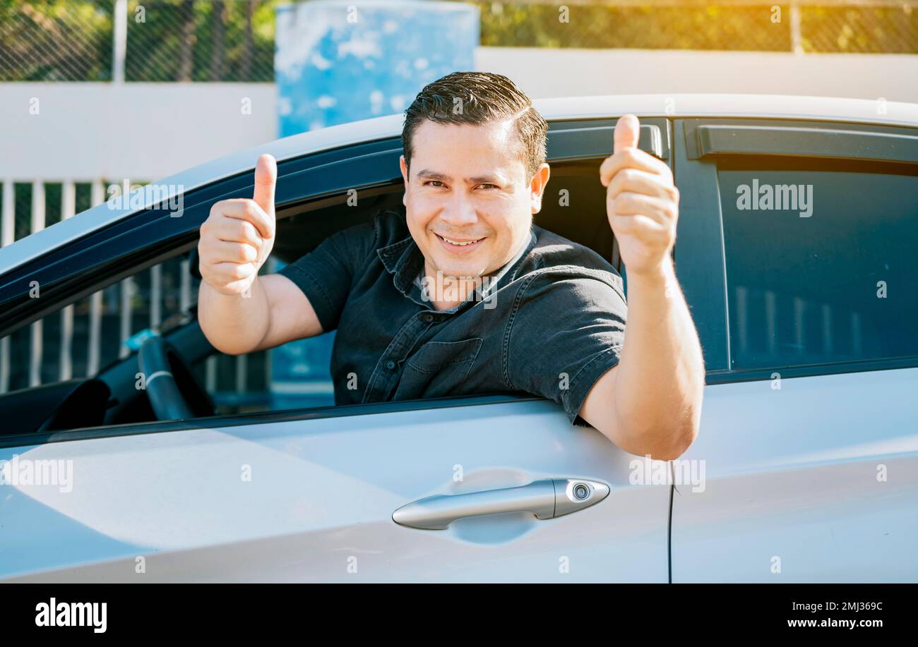 Happy driver giving a thumbs up on the road. safe driving concept ...