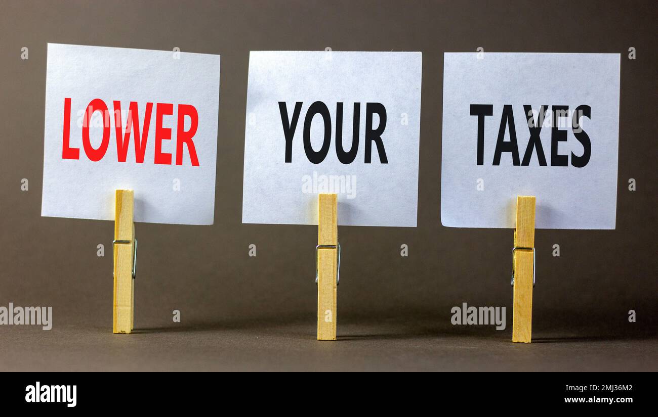 Lower your taxes symbol. Concept words Lower your taxes on white paper ...