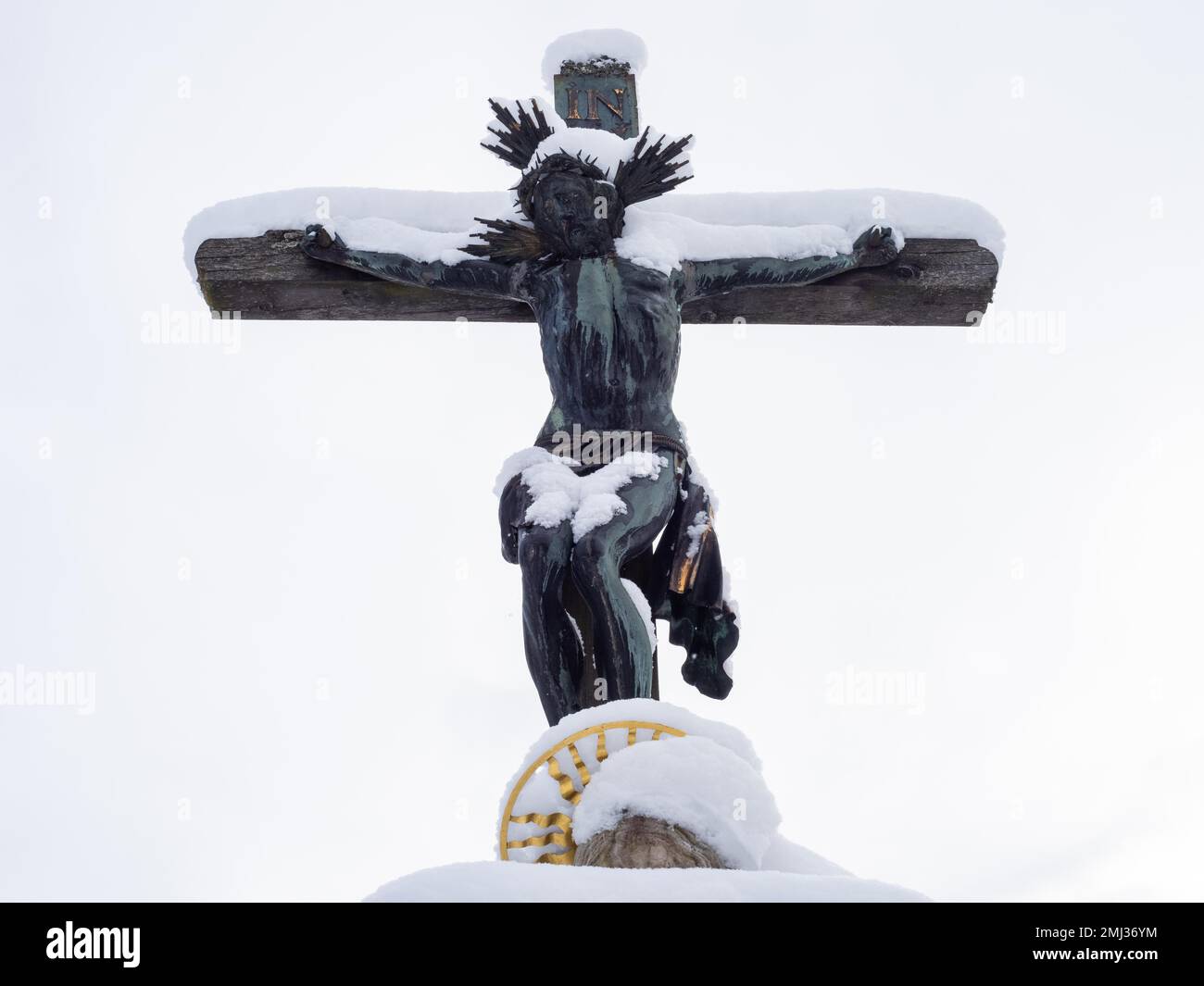 Fresh snow, Jesus on the cross, part of the crucifixion group on Calvary, work by Josef Stammel ...