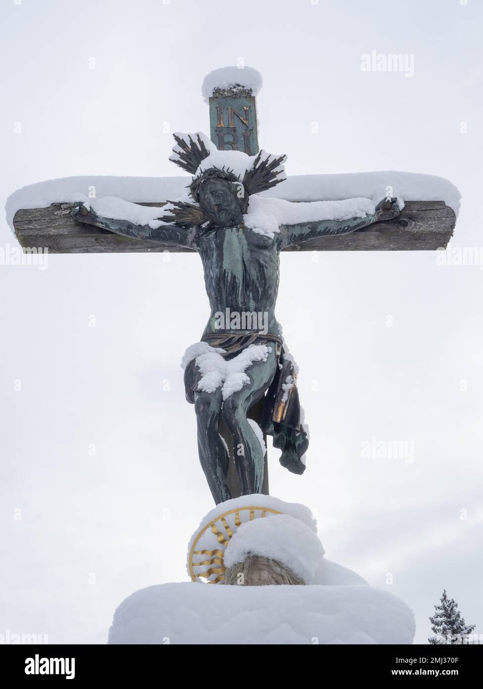 Fresh snow, Jesus on the cross, part of the crucifixion group on Calvary, work by Josef Stammel ...