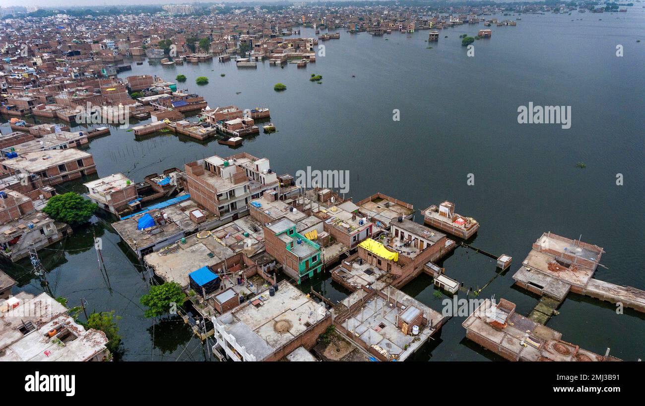 Floodwaters surround the areas by the River Ganges in Prayagraj, India ...