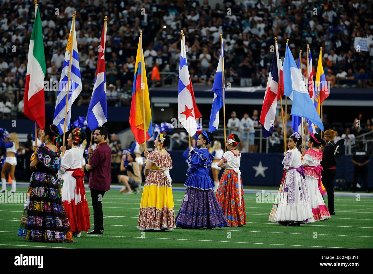 Dancers hold flags of nations of hispanic heritage honoring Hispanic ...