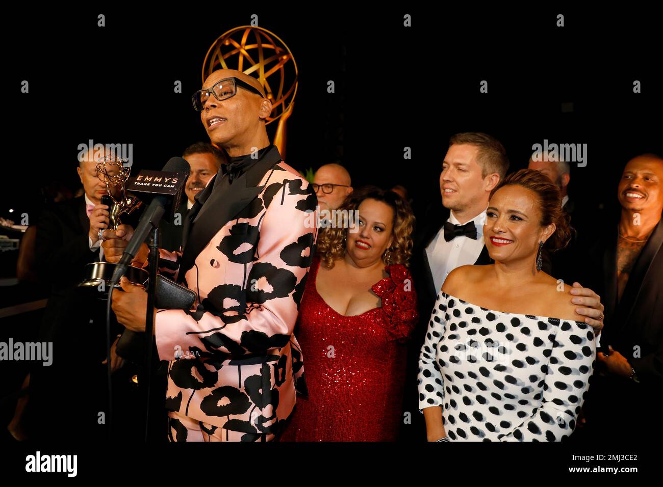 RuPaul, left, and the cast and crew backstage pose with the award for ...