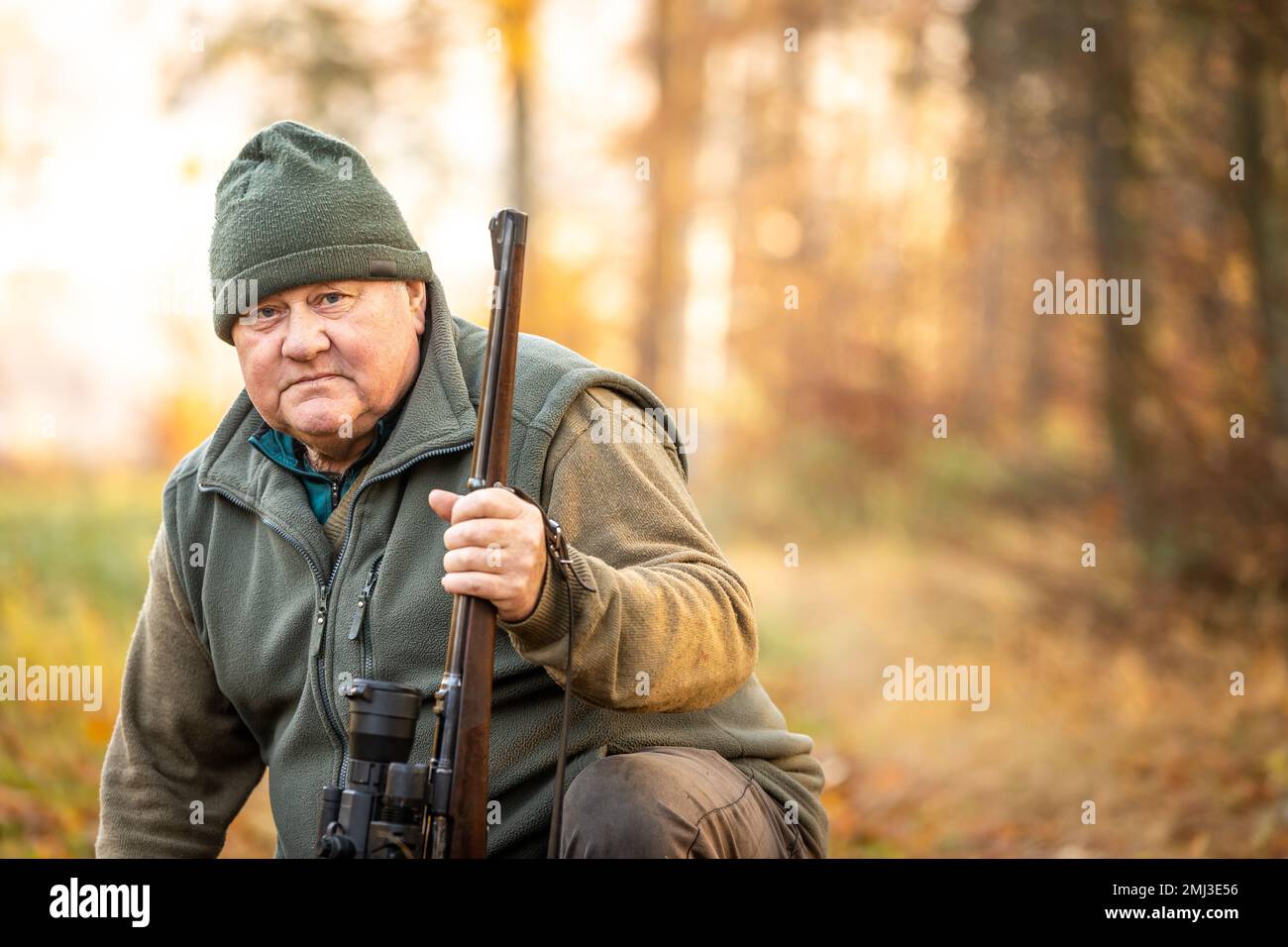 Portrait of hunter or ranger with a hunting gun and hunting form to ...
