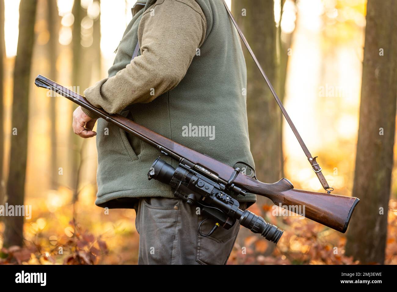 Hunter or ranger with a professional, nightvision hunting gun and ...