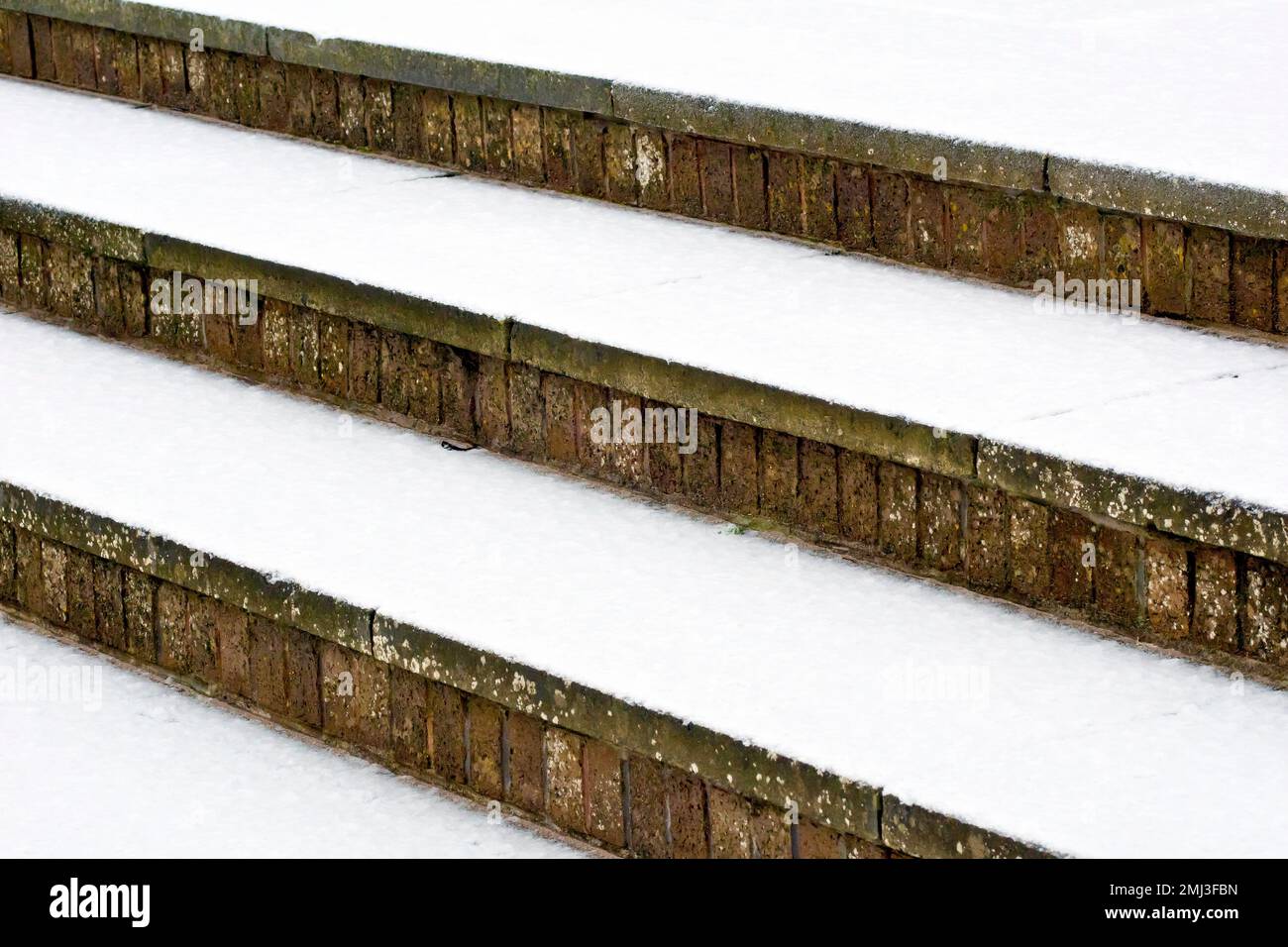 Close up of a wide shallow set of brick steps, each level covered in a ...