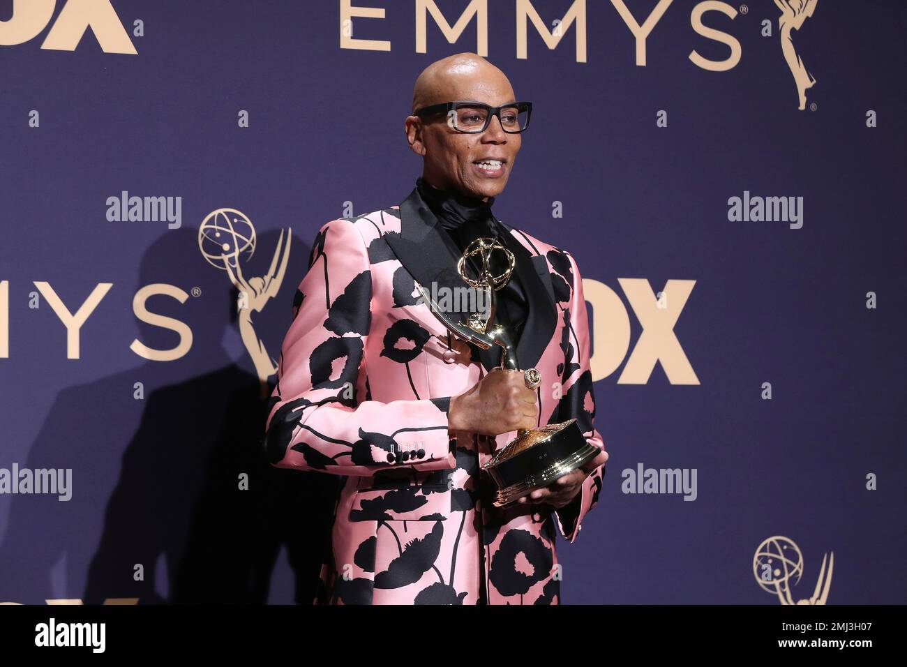 RuPaul poses in the press room with the award for "outstanding ...
