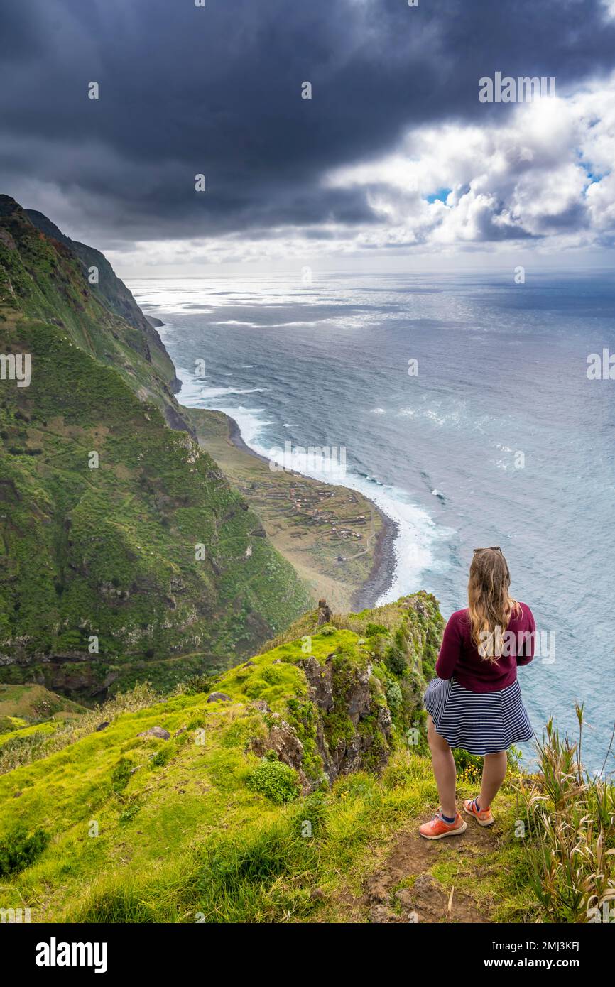 Young woman enjoying view of cliffs and sea, coastal landscape ...