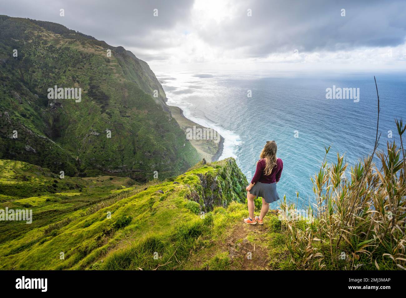 Young woman enjoying view of cliffs and sea, coastal landscape ...