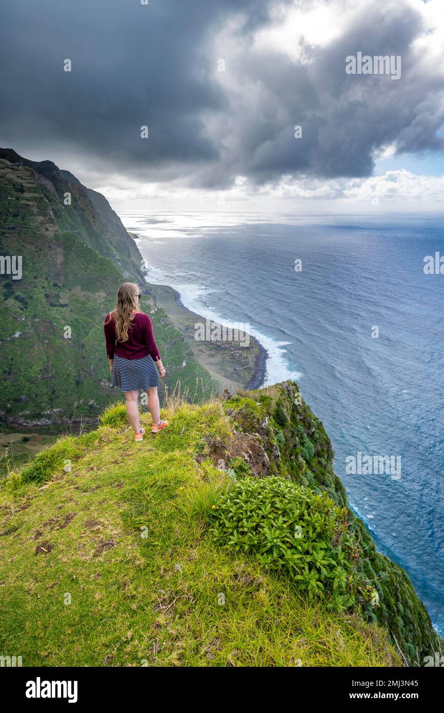 Young woman enjoying view of cliffs and sea, coastal landscape ...