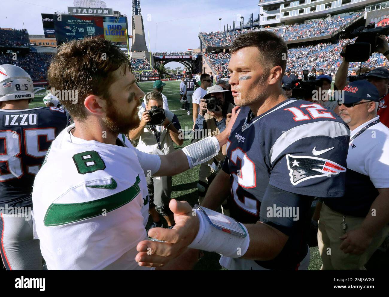 New York Jets quarterback Luke Falk, left, and New England Patriots quarterback Tom Brady speak ...