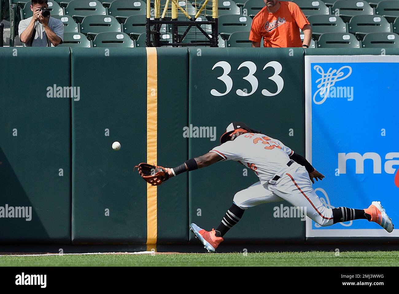 Baltimore Orioles' Dwight Smith Jr. reaches for a ball hit by Seattle ...