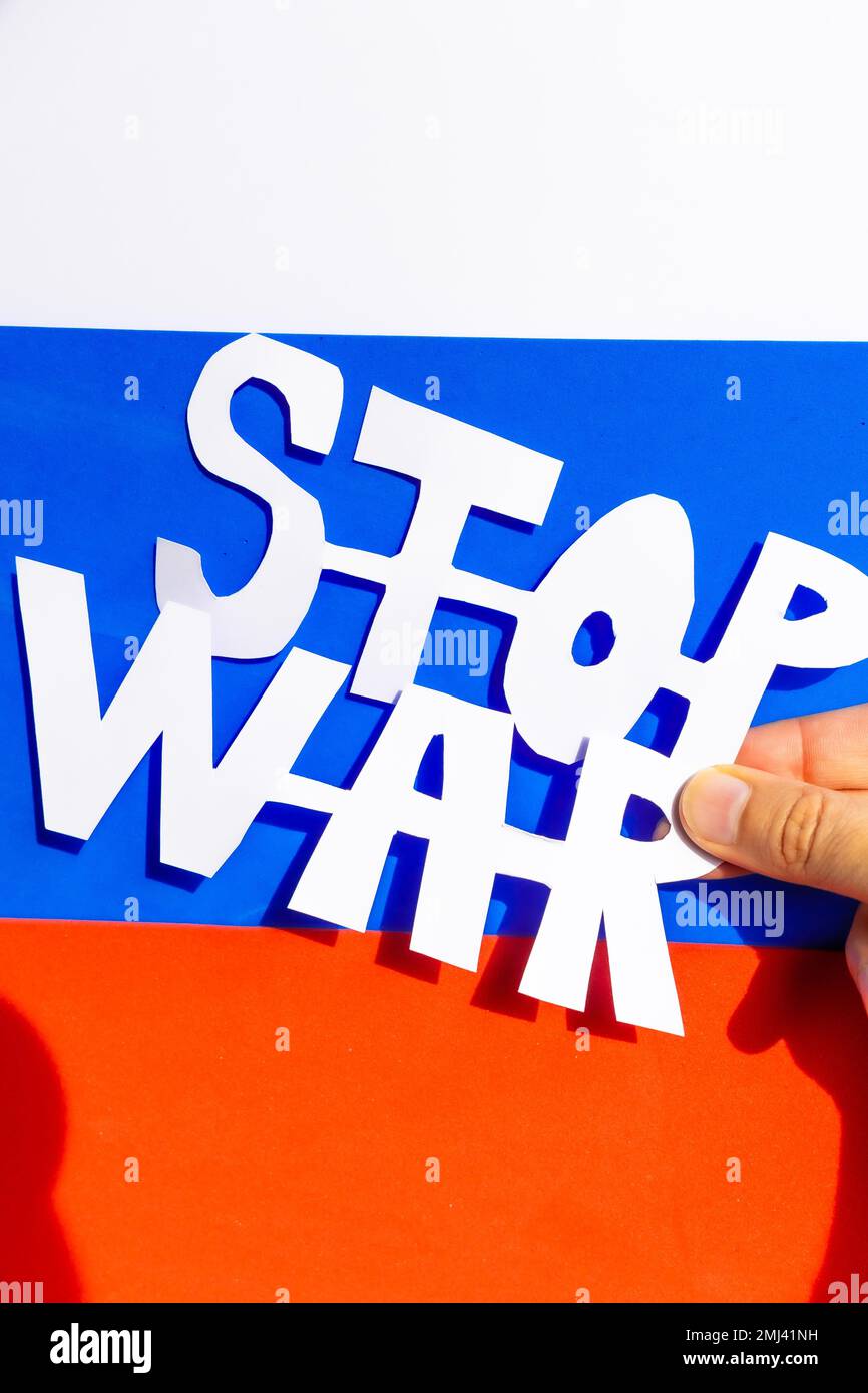 Stop war, conflict between Ukraine and Russia. A man holding a cutout ...