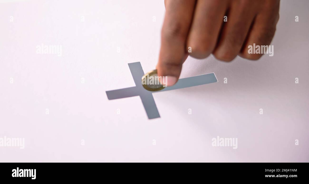 Hand Inserting Coin In Crucifix Slot. Donate Money Stock Photo - Alamy Hand Inserting Coin In Crucifix Slot. Donate Money Stock Photo - Alamy