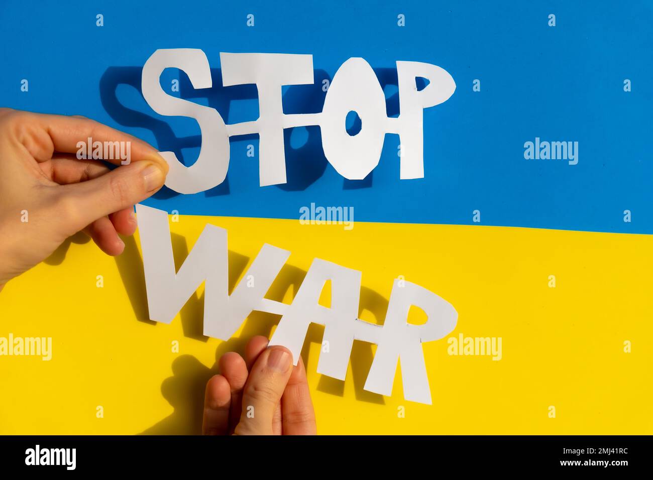 Stop war, conflict between Ukraine and Russia. A womans hands holding a ...