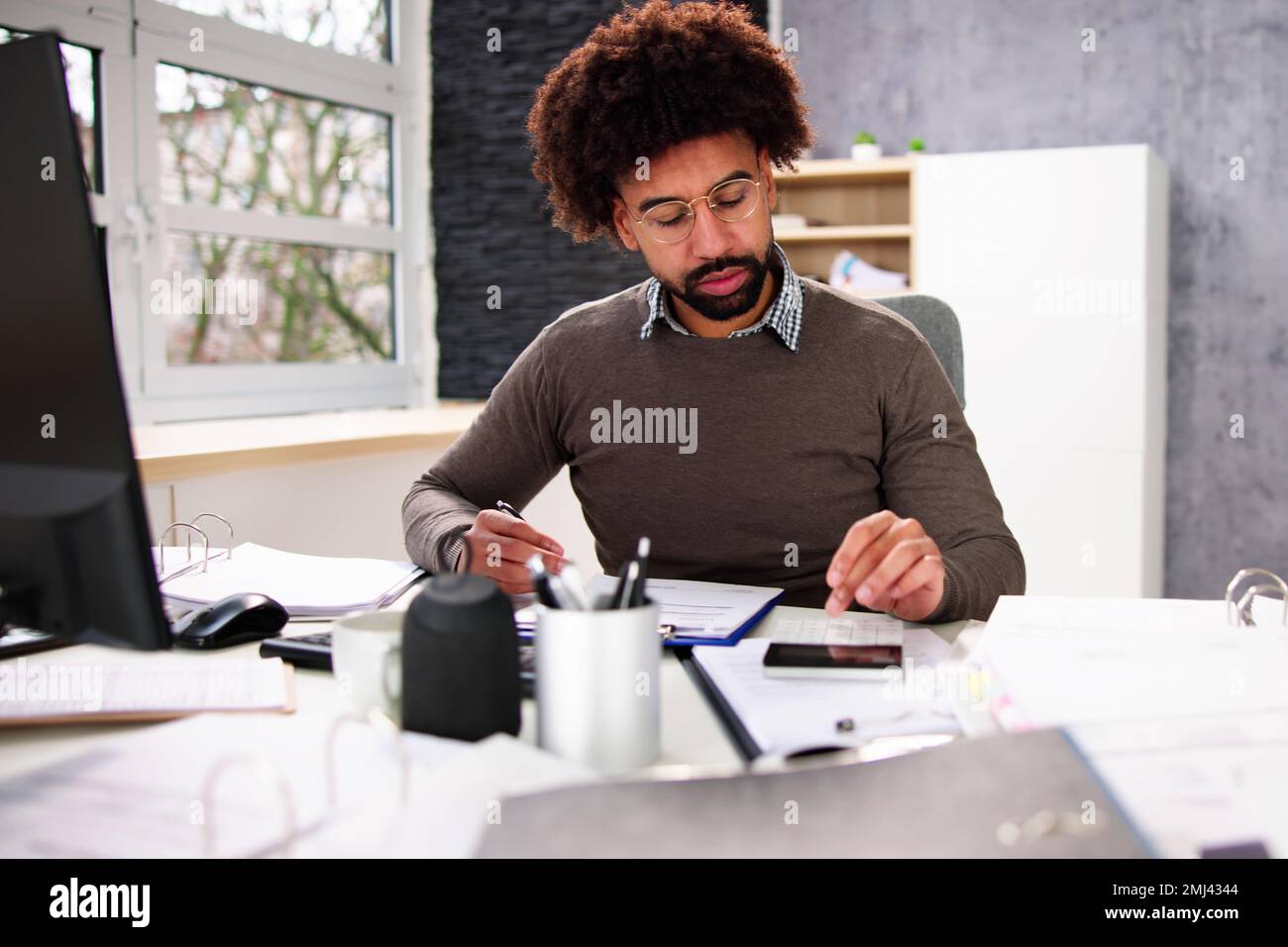 Portrait Of A Accountant Man Calculating Invoice Stock Photo - Alamy