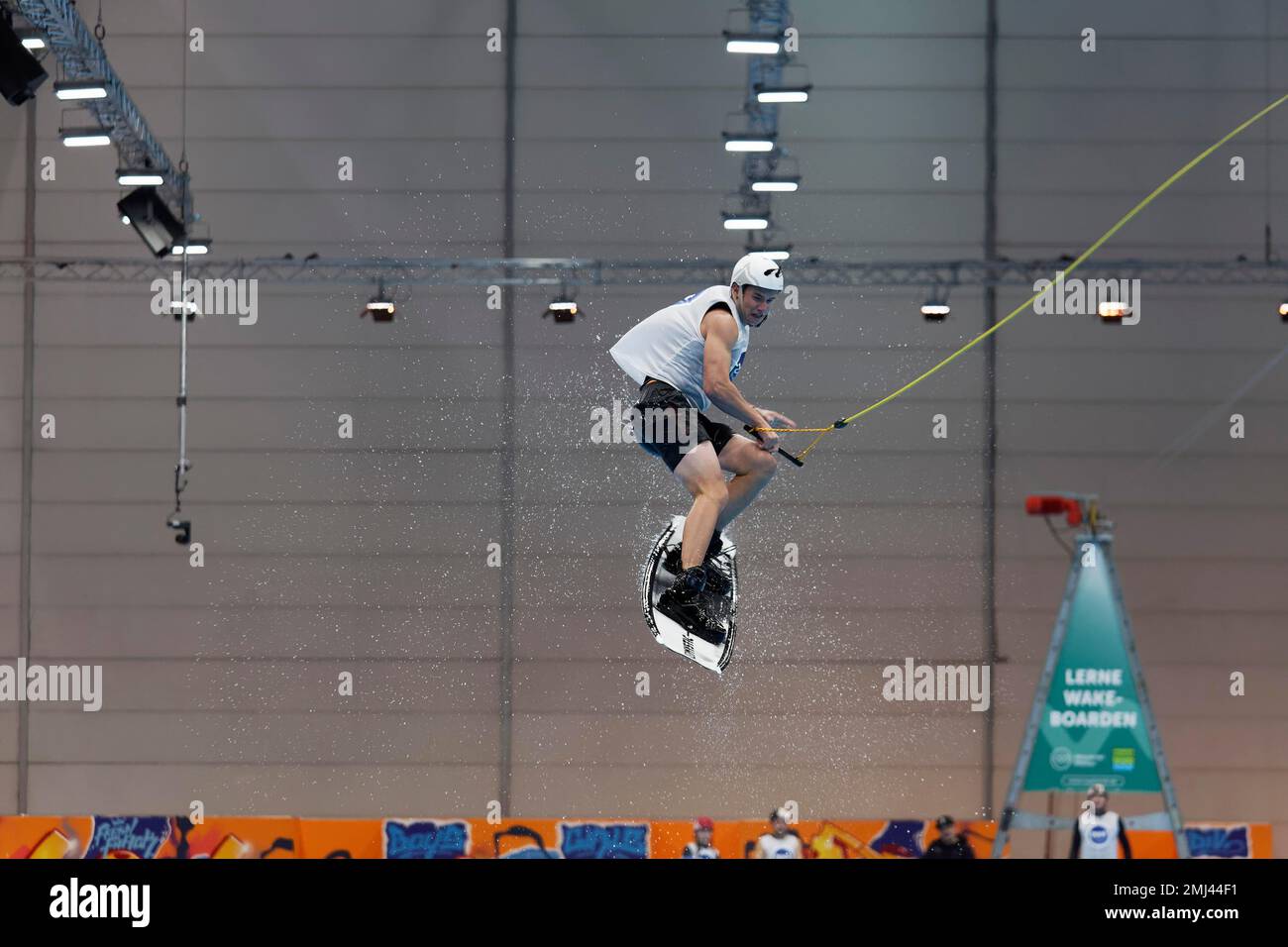 Wakeboard stunt at the lift, jump, demonstration in a hall with indoor ...