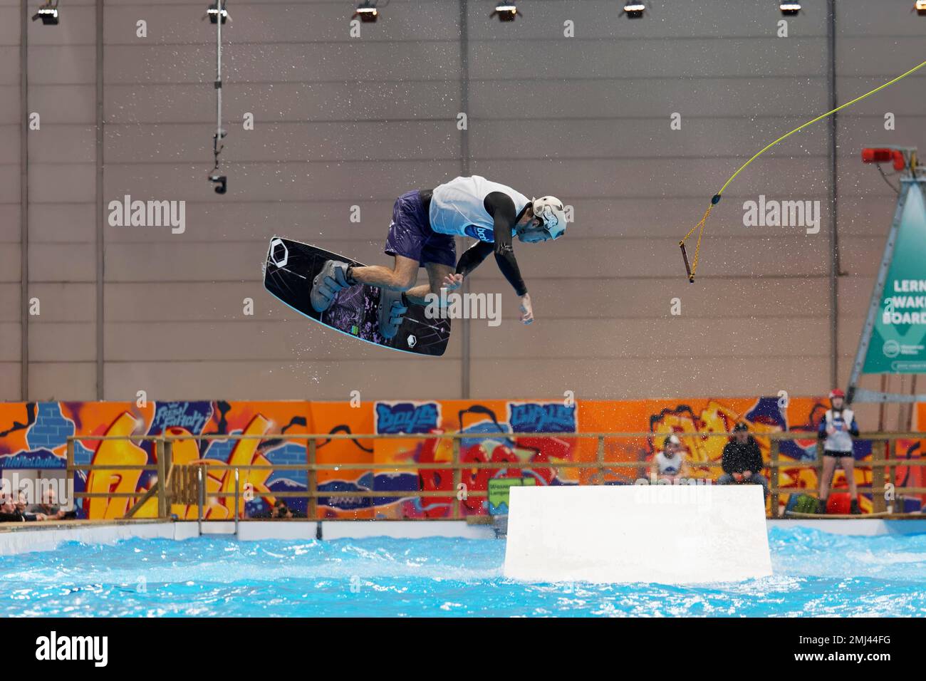 Wakeboard stunt, demonstrated in hall with indoor pool, watersports ...