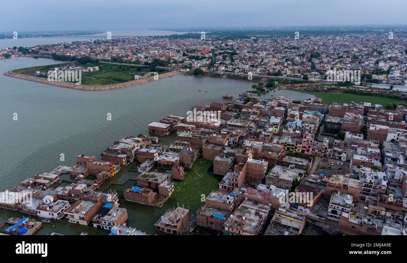 Floodwaters surround the areas by the River Ganges in Prayagraj, India ...