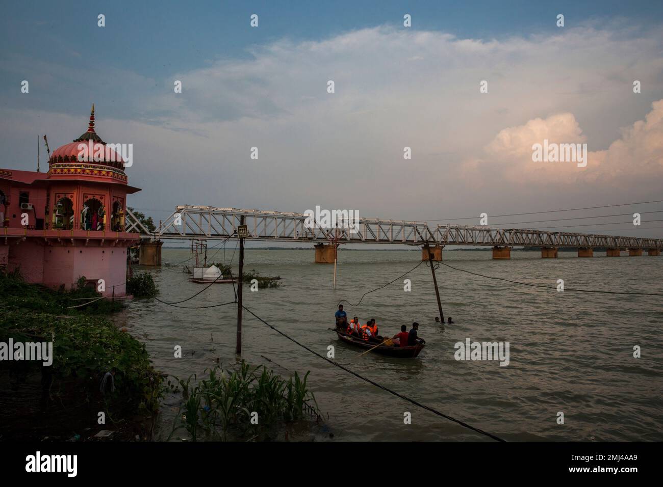 A boat moves in the swollen River Ganges in Prayagraj, India, Saturday ...