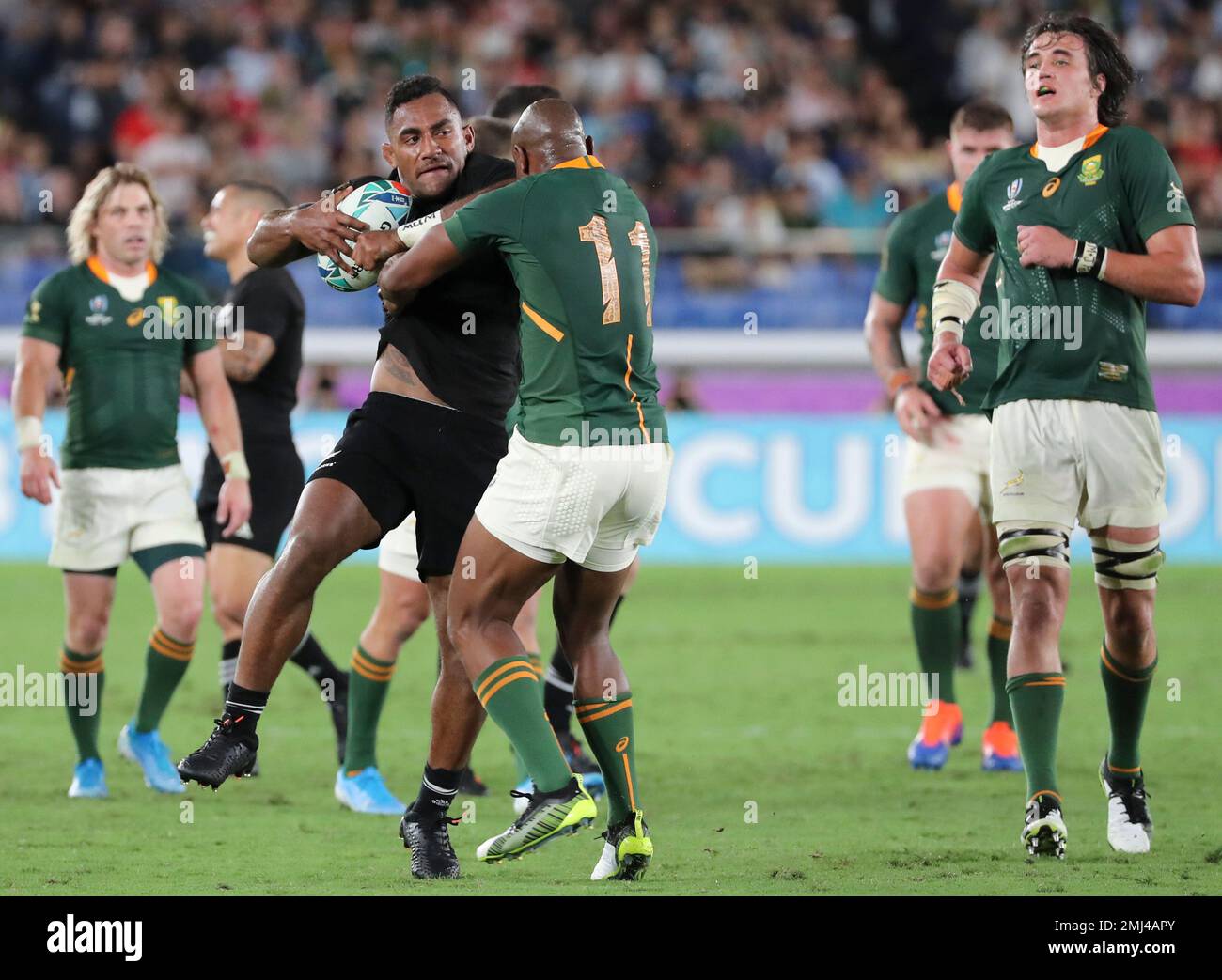 New Zealand's Sevu Reece, second from left, handles the ball as South ...