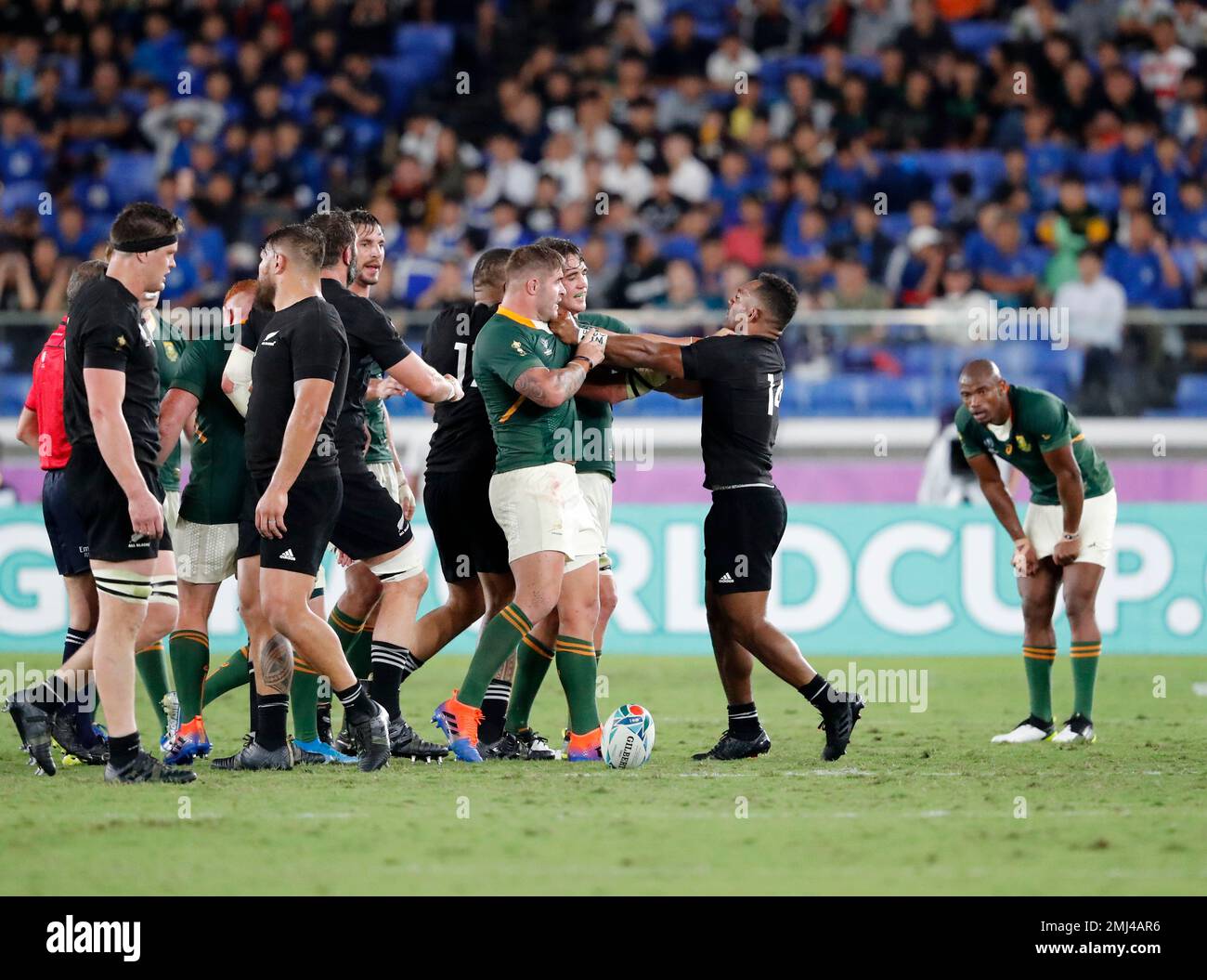 New Zealand's Sevu Reece, right, scuffles with South African players ...