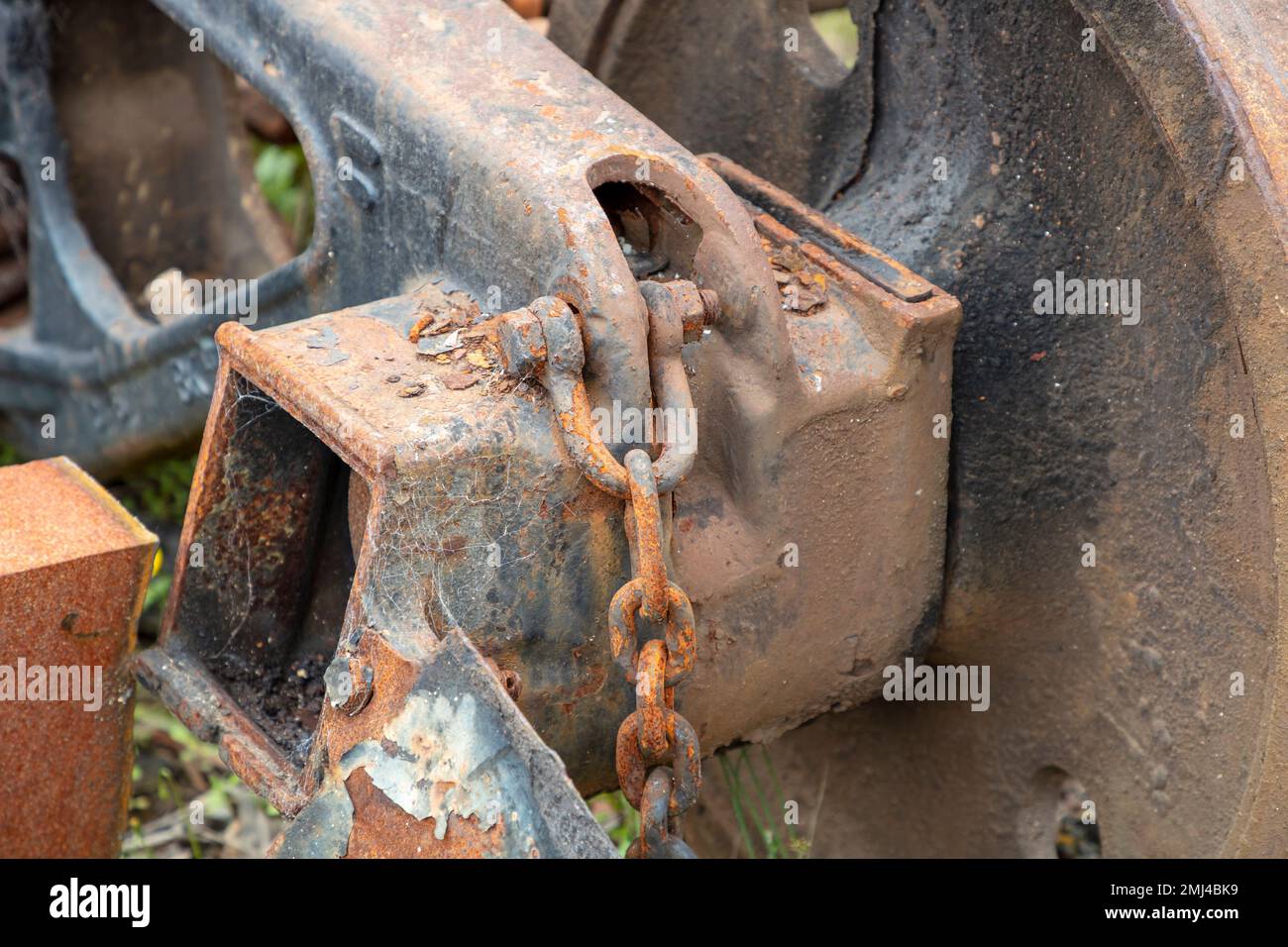 Photograph of old and rusty chain on a train bogie wheel assembly that ...