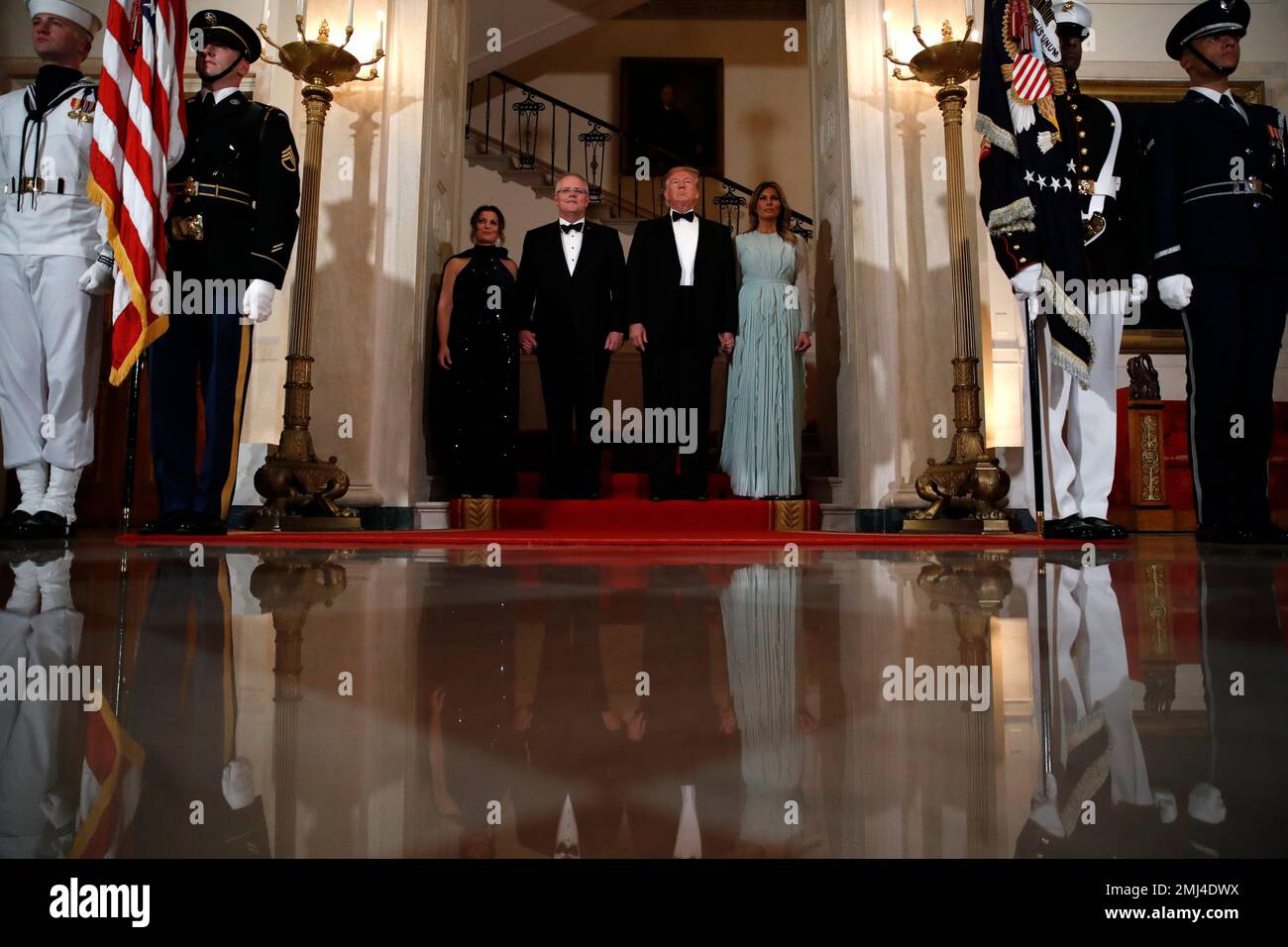 President Donald Trump and first lady Melania Trump stand with ...