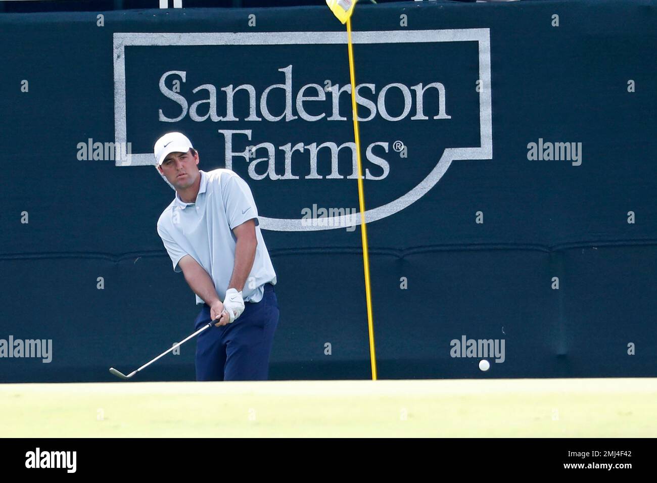 Scottie Scheffler watches his chip shot at the 18th pin during the second round of the Sanderson ...