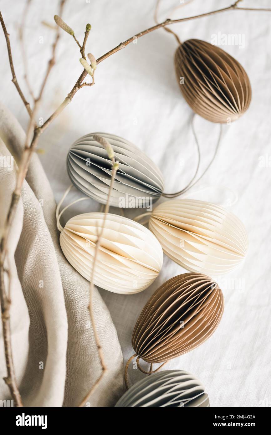 Easter egg-shaped pastel colored decorations, made out of cardboard and ...