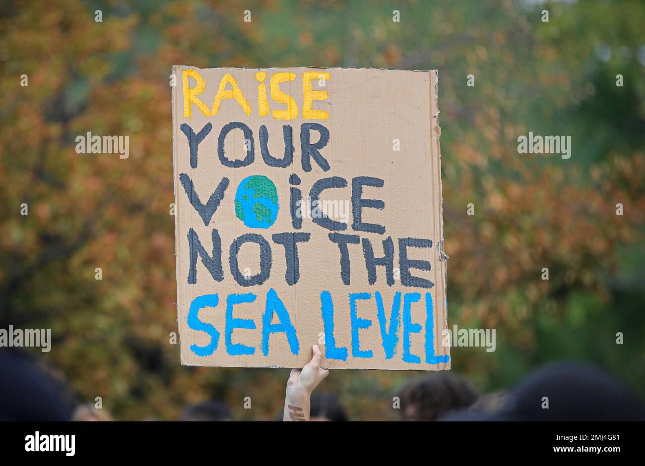 A climate activist holds a banner during a Climate Change protest in ...