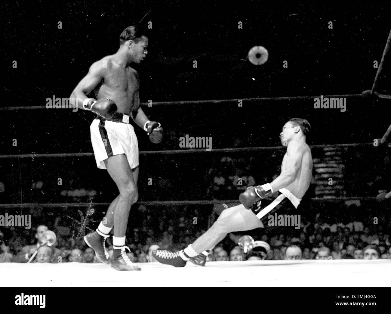 Welterweight champion Sugar Ray Robinson stands and watches his ...