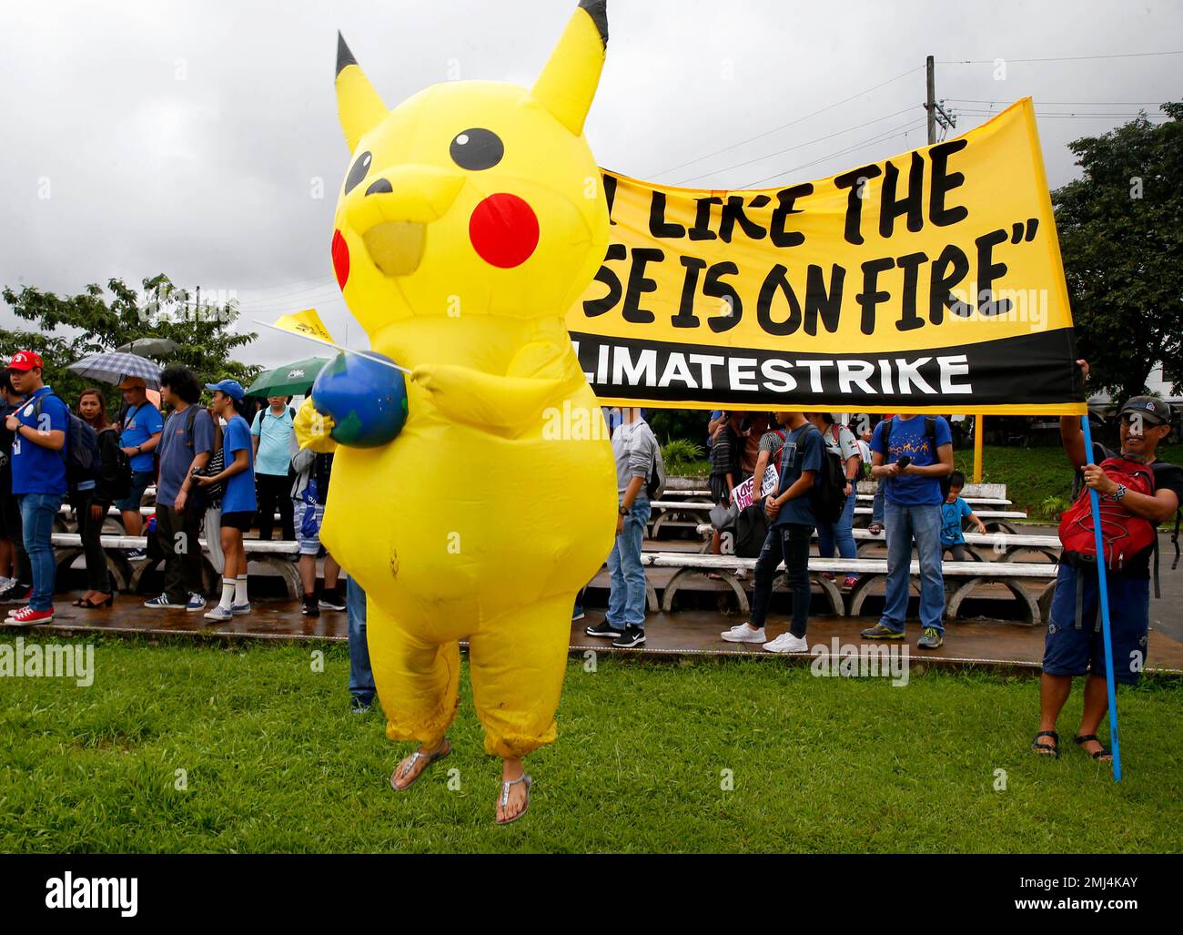 An environmental activist, wearing a "Pikachu" costume, poses during a ...