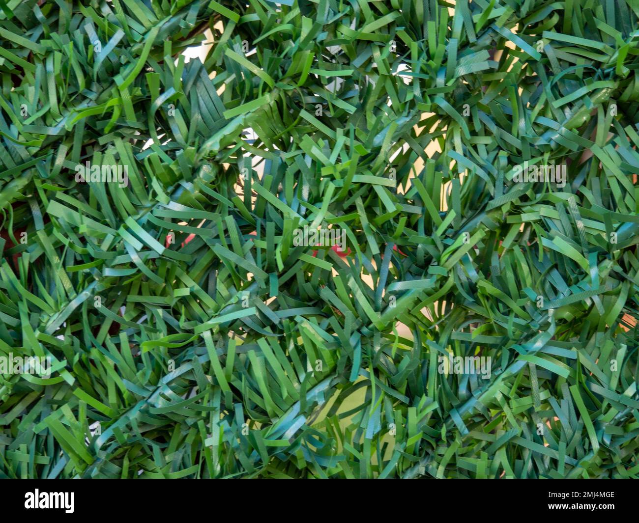 Artificial greenery. Artificial grass background. Plastic greenery on a ...