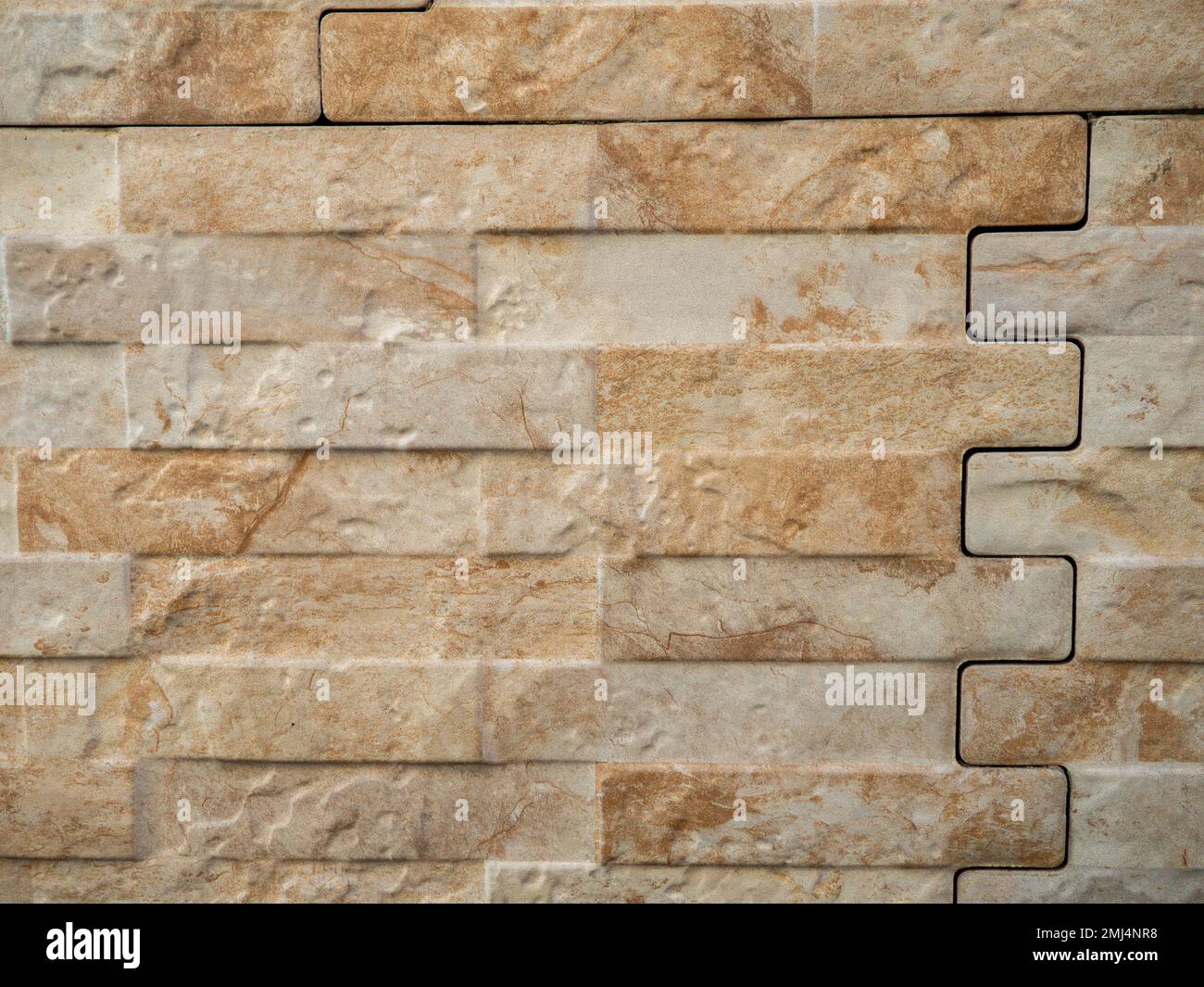 Wall of the house. Wall surface. Beige masonry. Smooth tile. Design ...