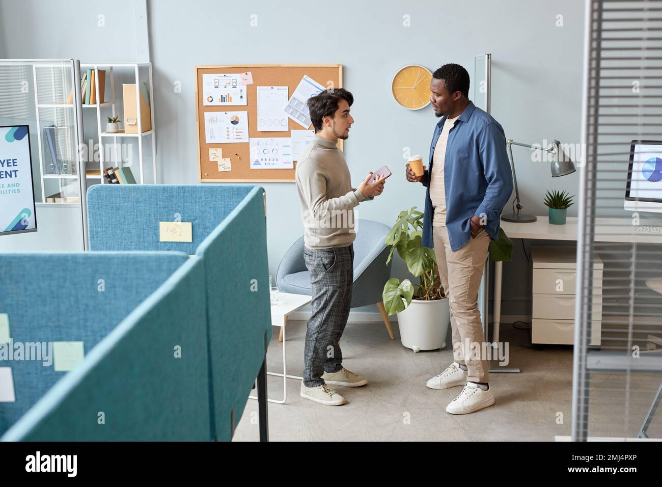 Full length side view portrait of two men wearing casual clothes ...