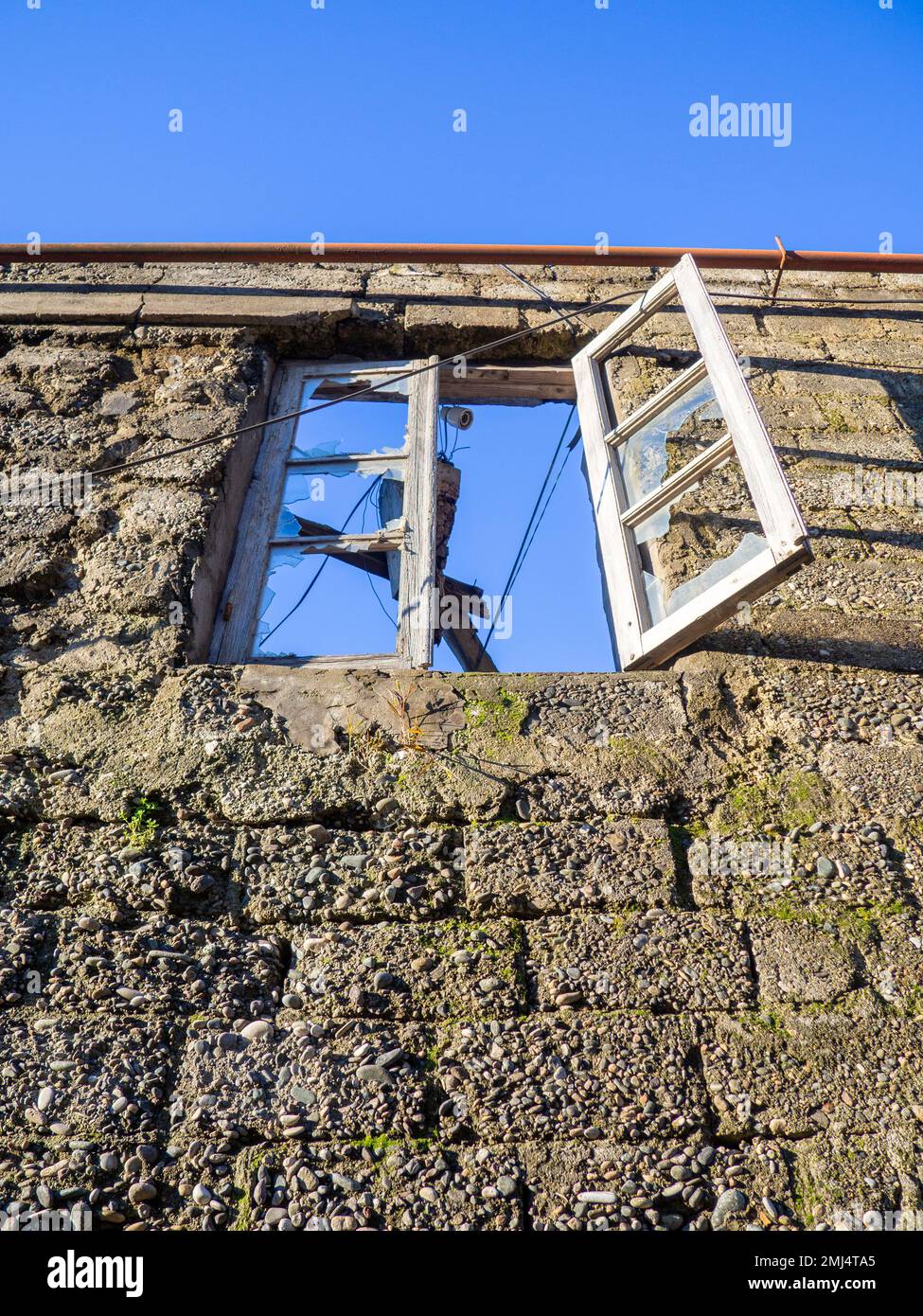 Window in a destroyed building. Remained a wall from the house. The ...