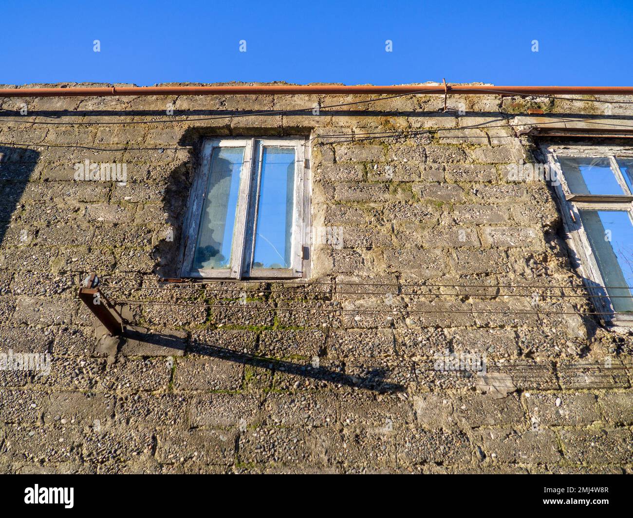 Window in a destroyed building. Remained a wall from the house. The ...