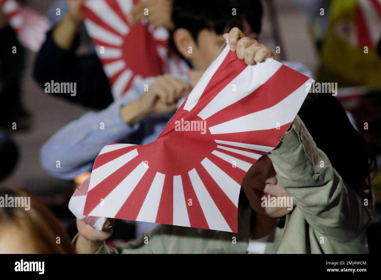 South Korean protesters tear Japanese rising sun flags during a rally ...