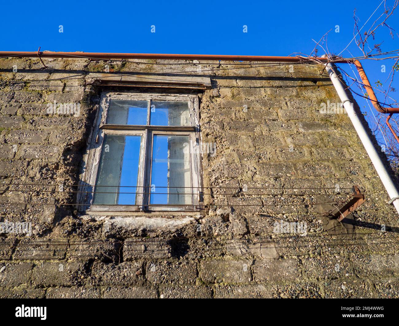 Window in a destroyed building. Remained a wall from the house. The ...