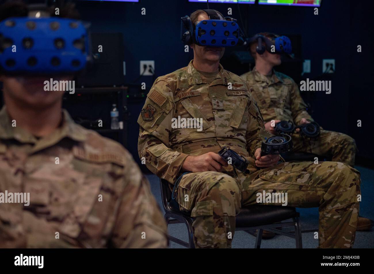 Maj. Gen. Corey Martin, 18th Air Force commander, looks through a ...