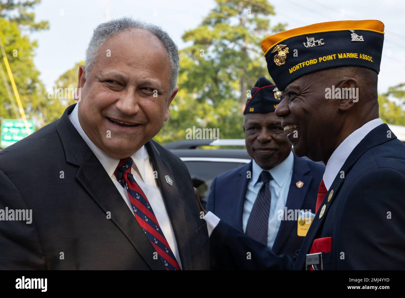 Secretary of the Navy Carlos Del Toro greets retired Sgt. Maj. Johnny B ...