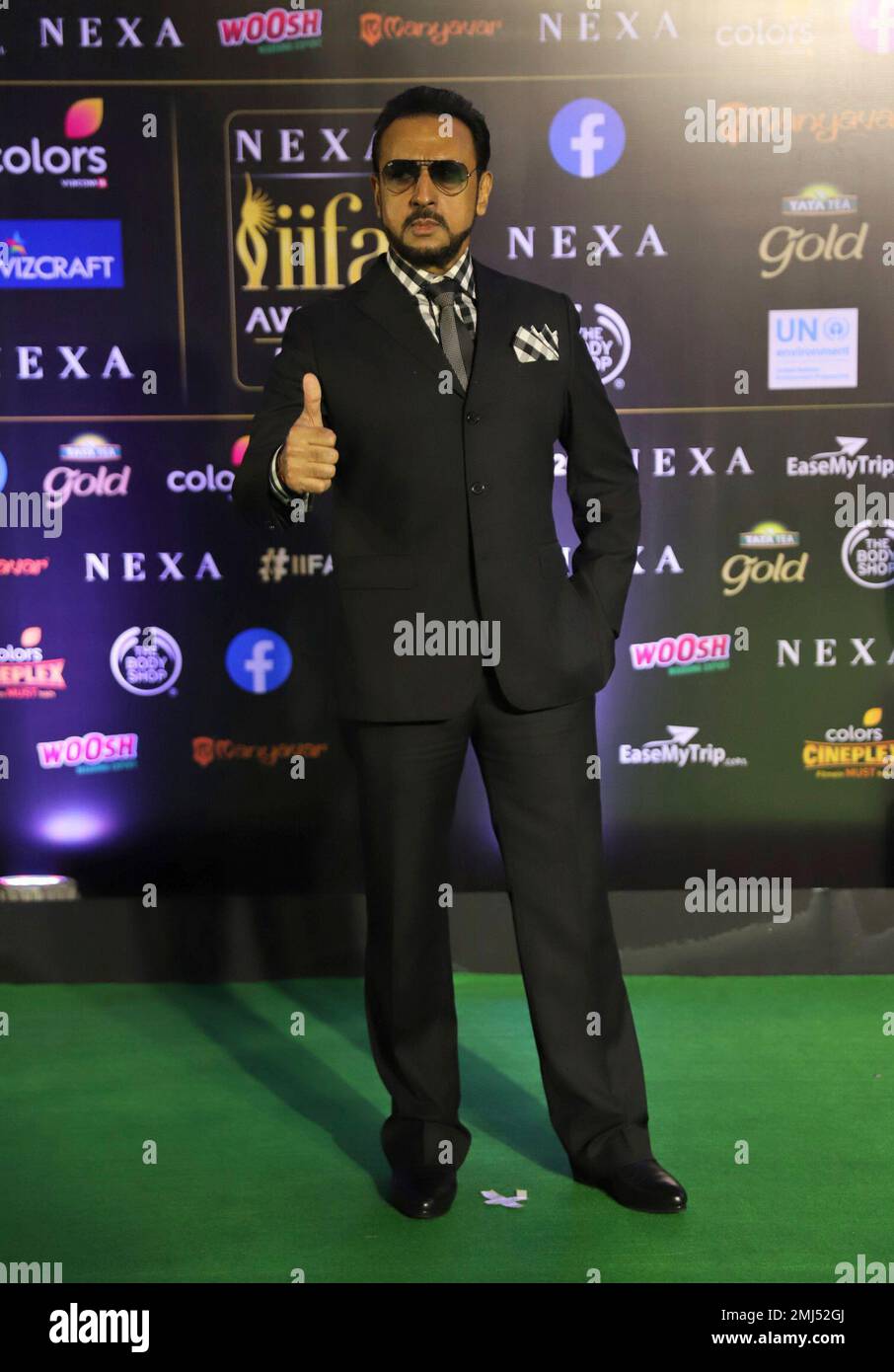 Bollywood actor Gulshan Grover stands for photographs as he arrives to ...