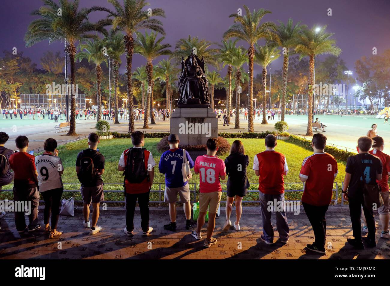 Pro-democracy football fans gather to form a human chain near a bronze ...